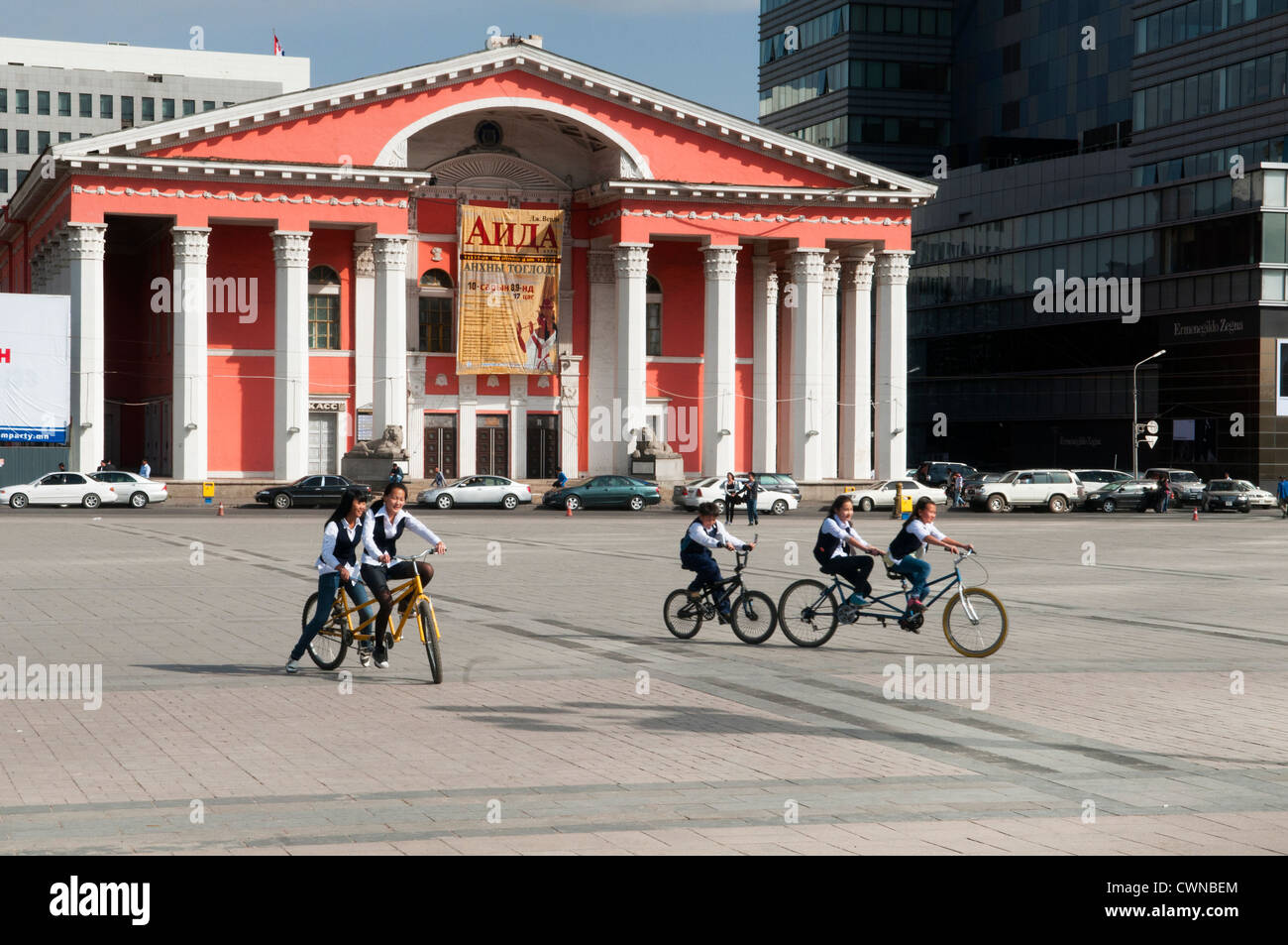 riding bicycles in front of the opera house in Ulan Baatar, Mongolia ...