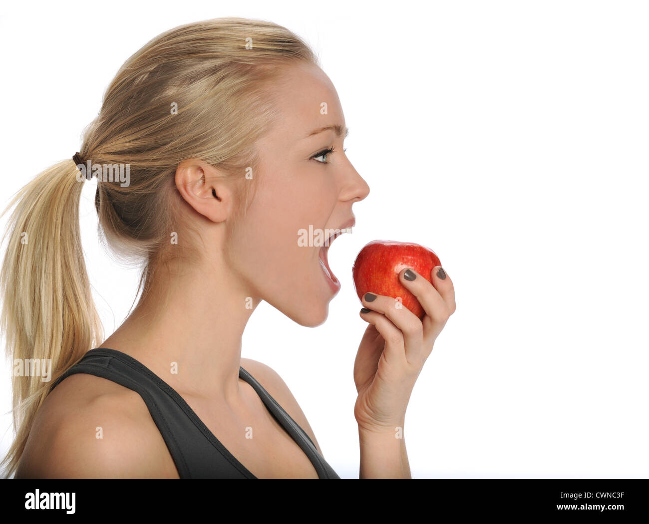 Beautiful young woman eating red apple isolated over white background ...