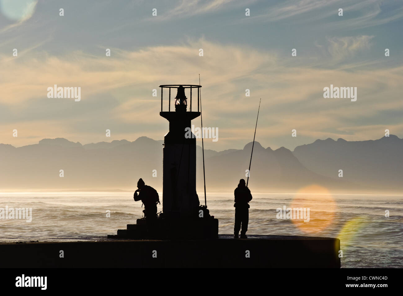 Fishermen Fishing at the Lighthouse in Harbour Stock Photo - Alamy