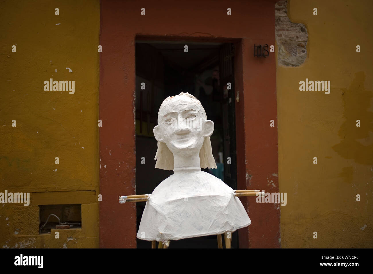 A giant paper mache man dries in the sun during the Guelaguetza ...