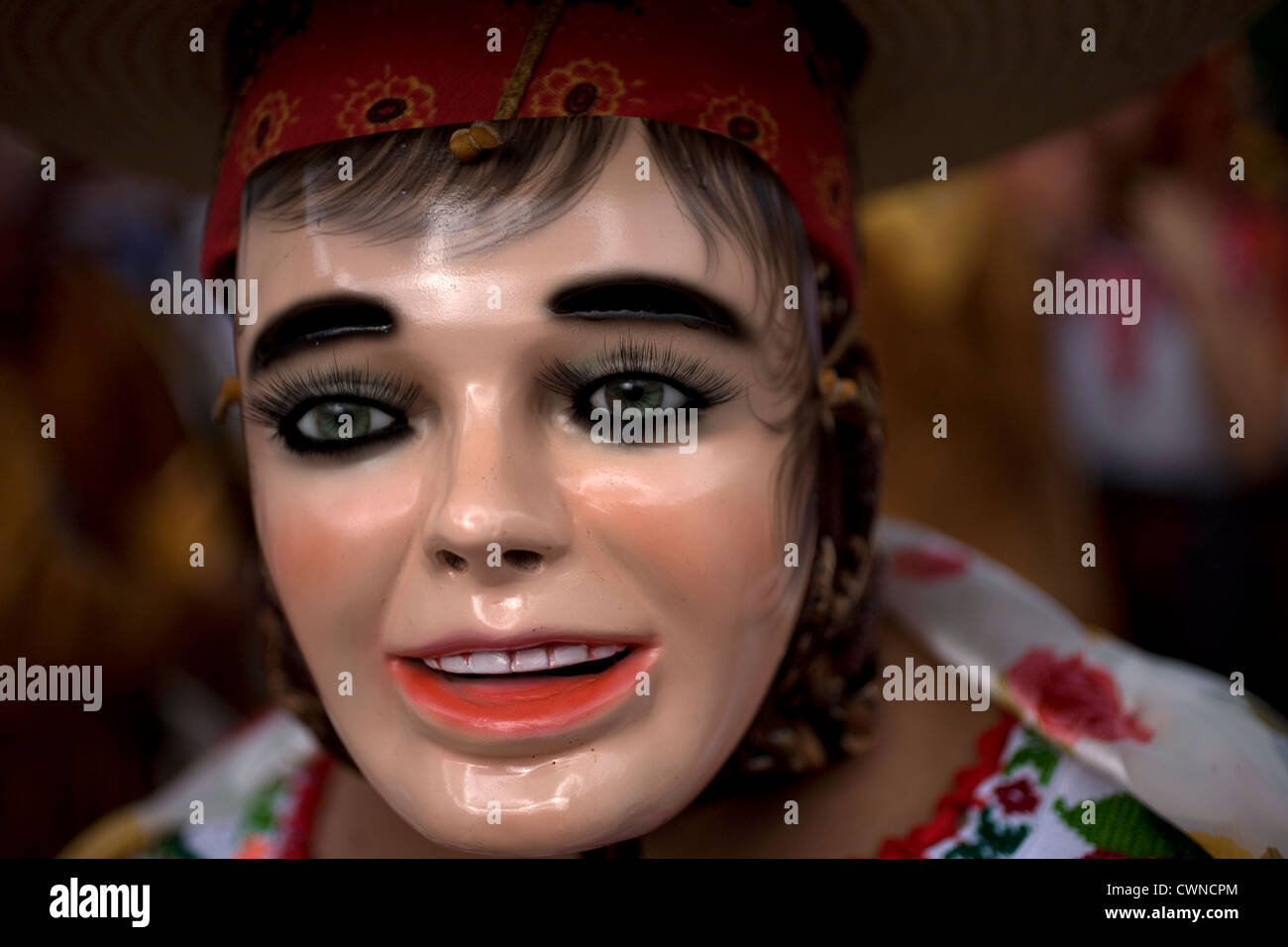 A woman wears a mask during the Guelaguetza parade in Oaxaca, Mexico ...