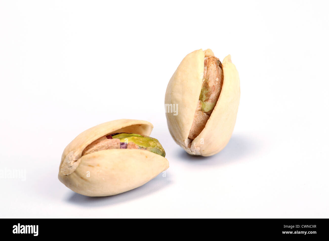 Roasted pistachios spilled on white background Stock Photo - Alamy