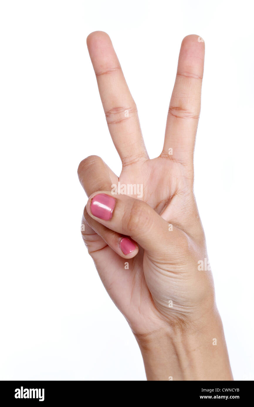 Hand making victory sign against white background Stock Photo - Alamy