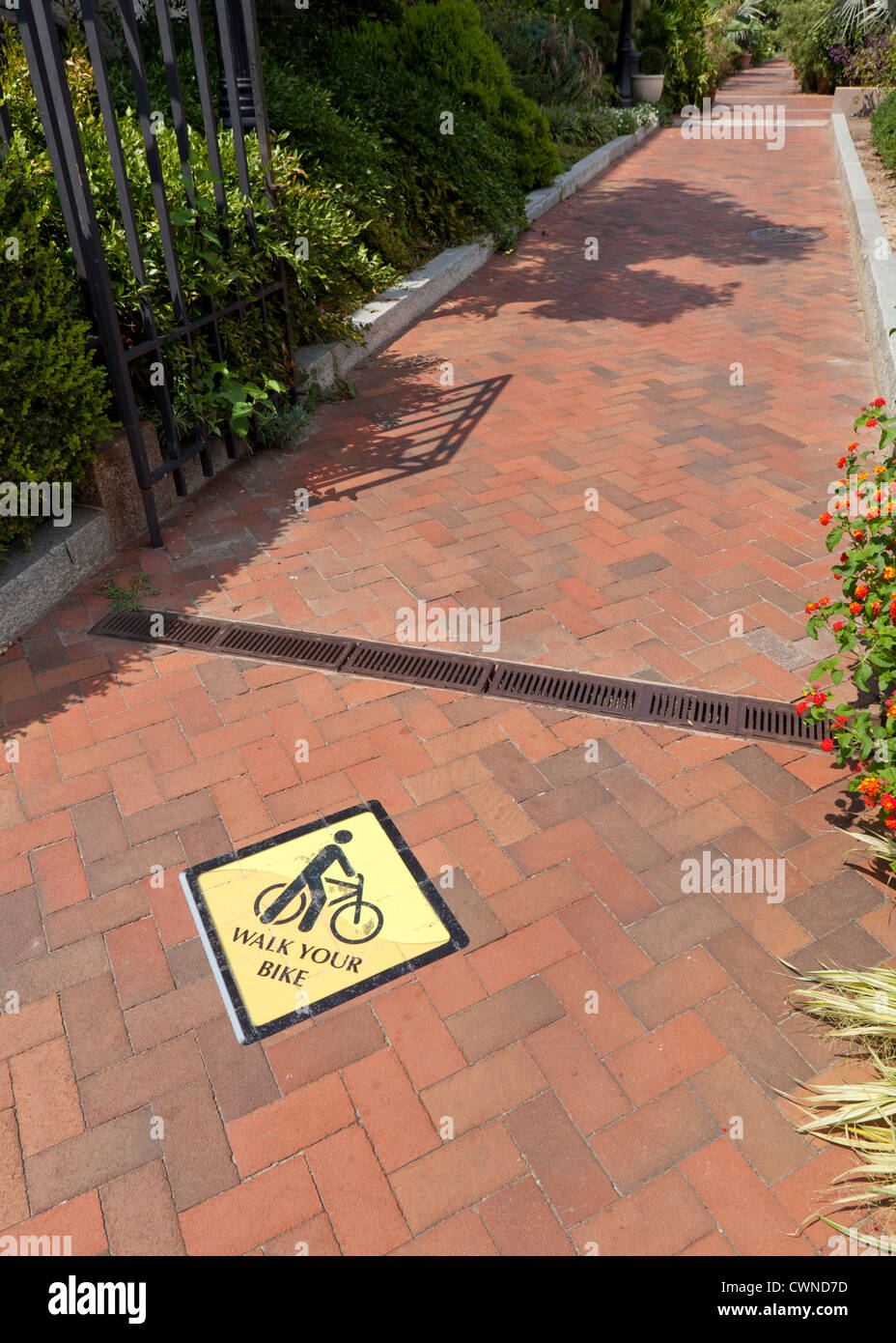 "Walk Your Bike" sign on brick walkway Stock Photo - Alamy