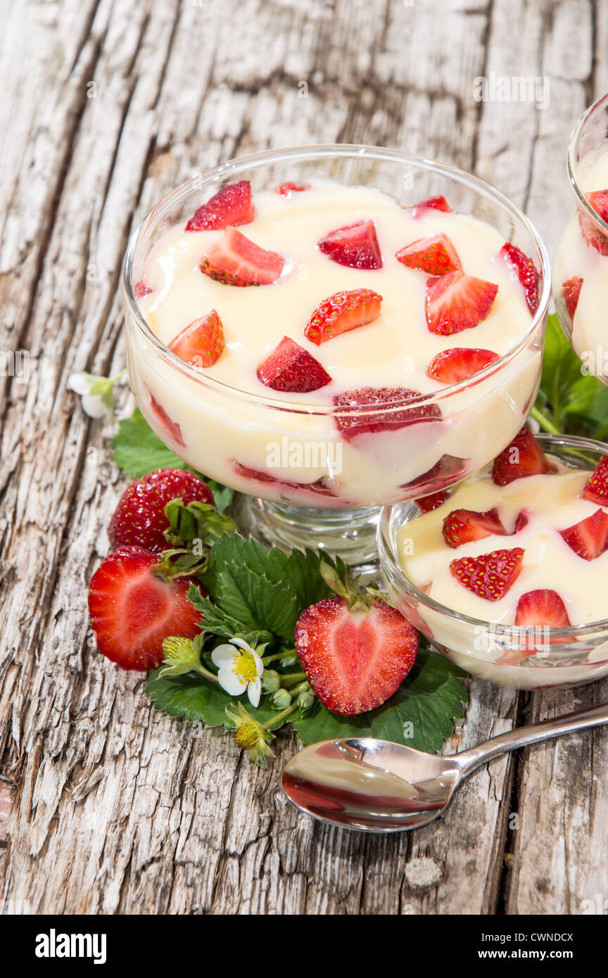 Vanilla Pudding in Bowls with fresh Fruits on wooden background Stock ...
