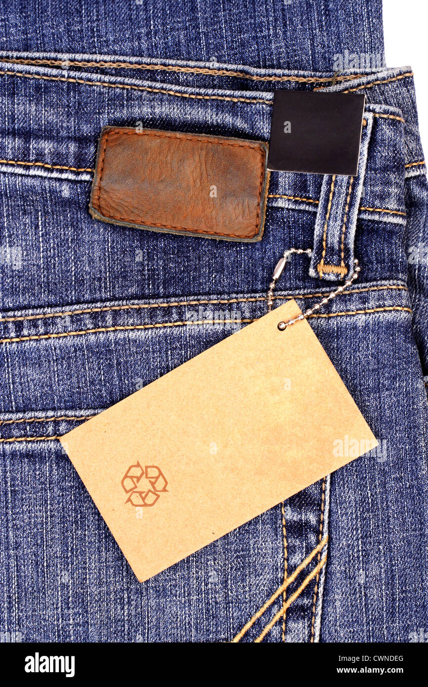 Vintage paper tag on the blue jean Stock Photo - Alamy