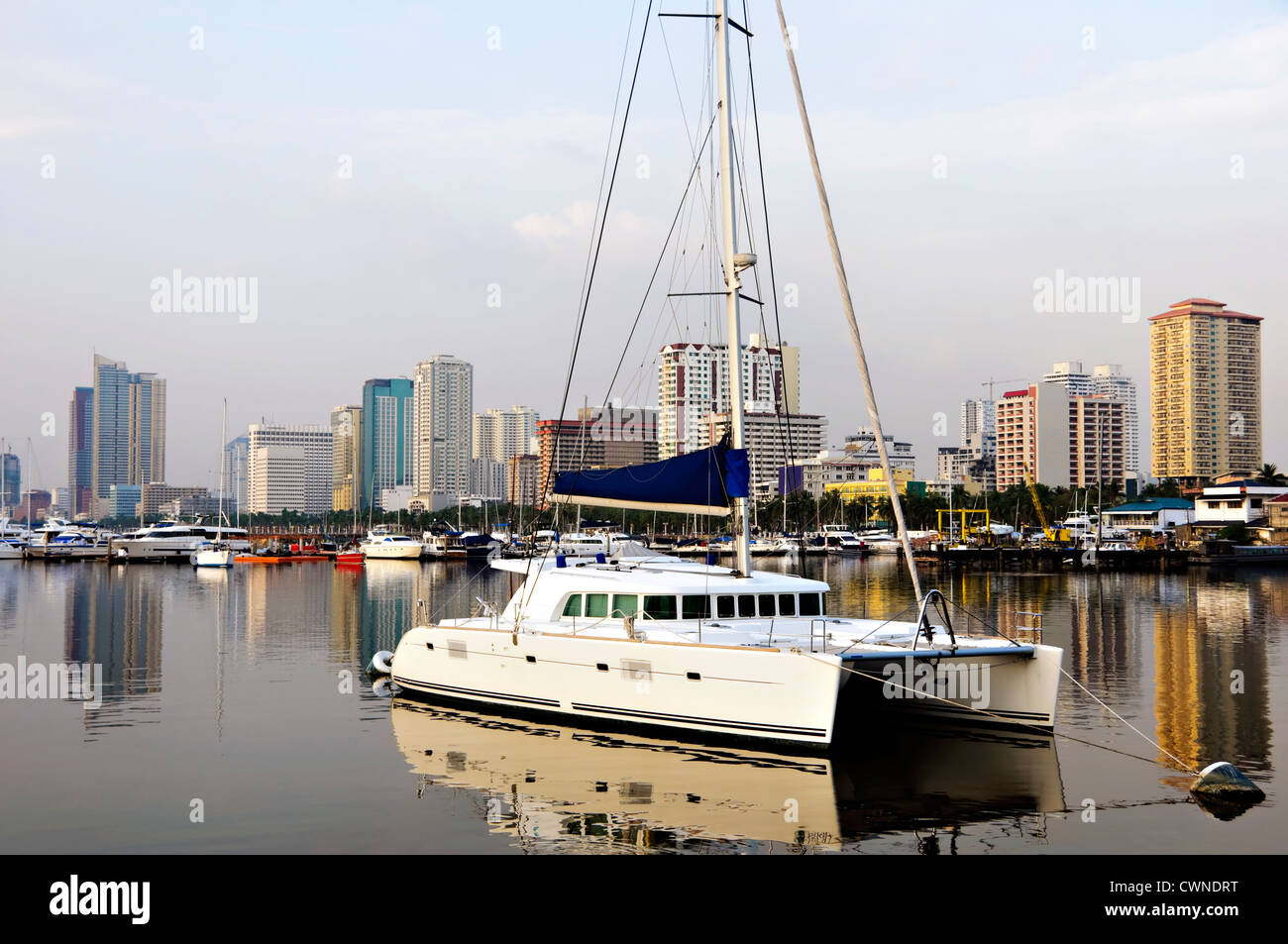 White sailboat anchored in Manila Bay, Philippines Stock Photo - Alamy