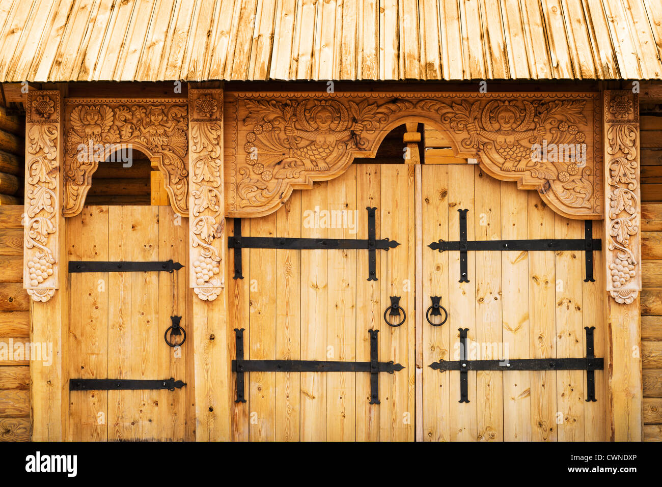 Wooden gate richly decorated with mythology images Stock Photo - Alamy