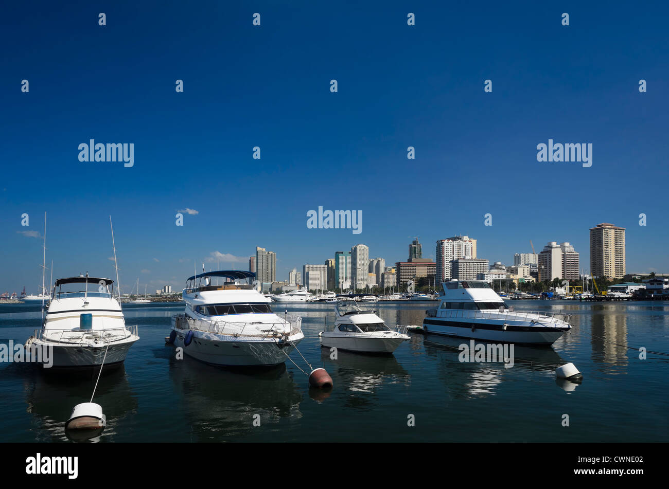 White boats anchored in Manila Bay, Philippines Stock Photo - Alamy