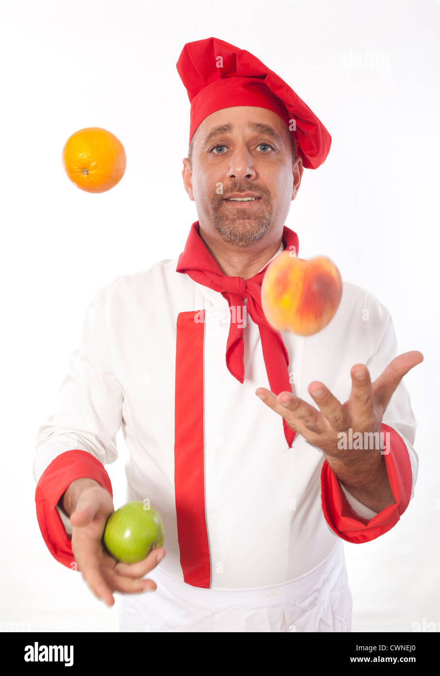 Male chef juggling fruit Stock Photo - Alamy
