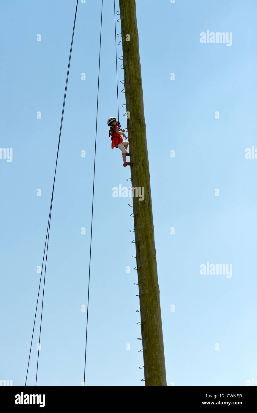 New Forest County Show child climbing pole Stock Photo - Alamy