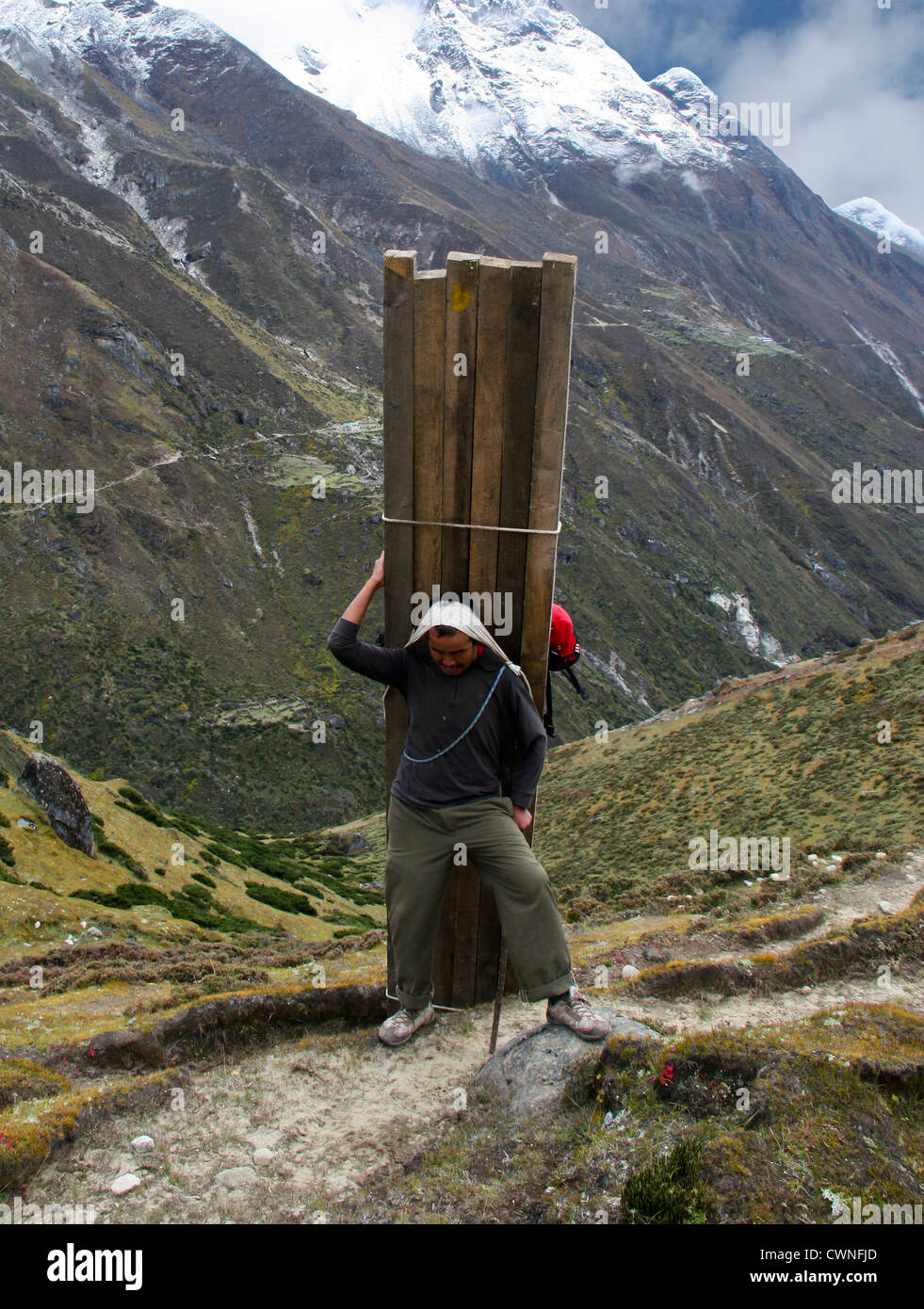 Nepalese porter carrying amazingly heavy load on his backs, 4400m up ...