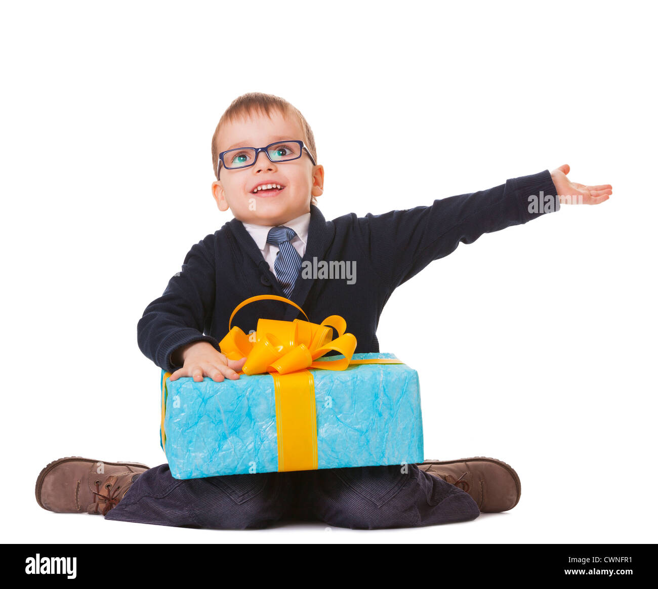 Small sitting boy in spectacles with big present on white background ...