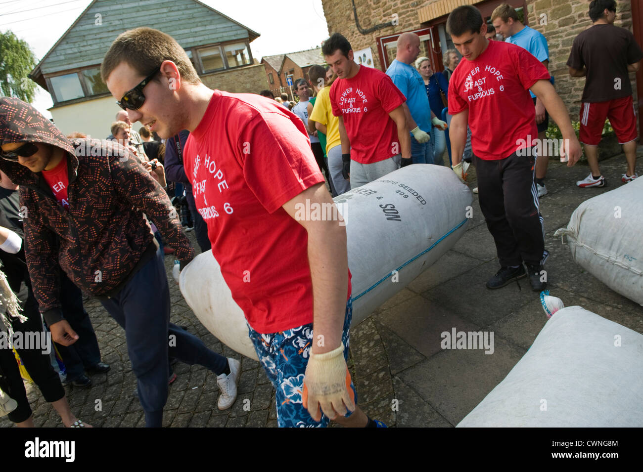 East European competitors try the 70kg hop pocket (sack) to be carried ...