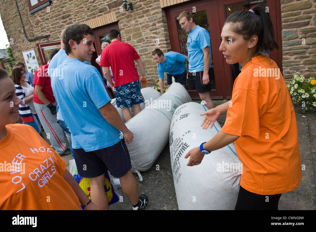 East European competitors try the 70kg hop pocket (sack) to be carried ...