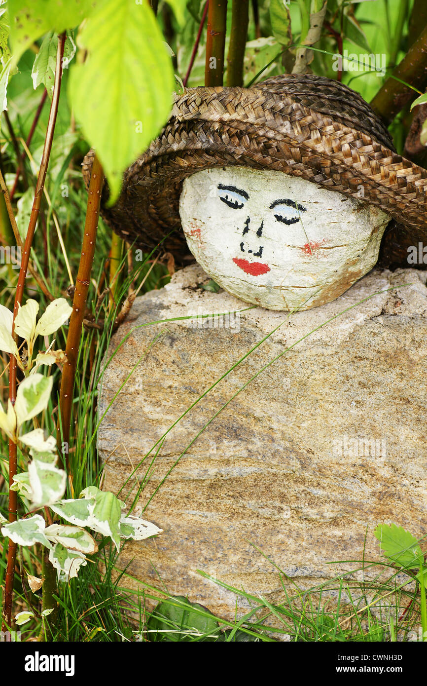 Original homemade garden decoration with round painted rock as a woman ...