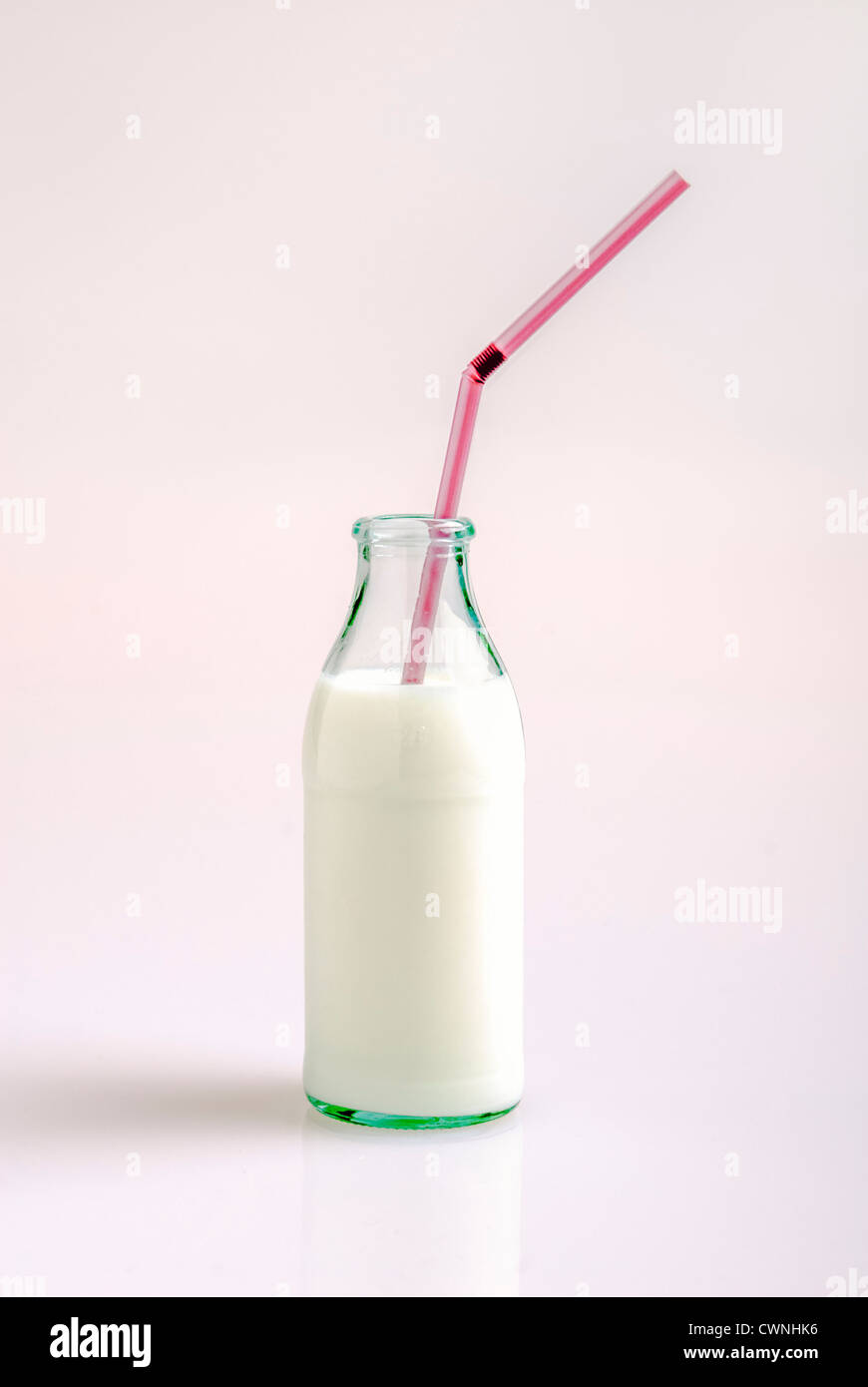 Milk in a bottle with a straw Stock Photo - Alamy