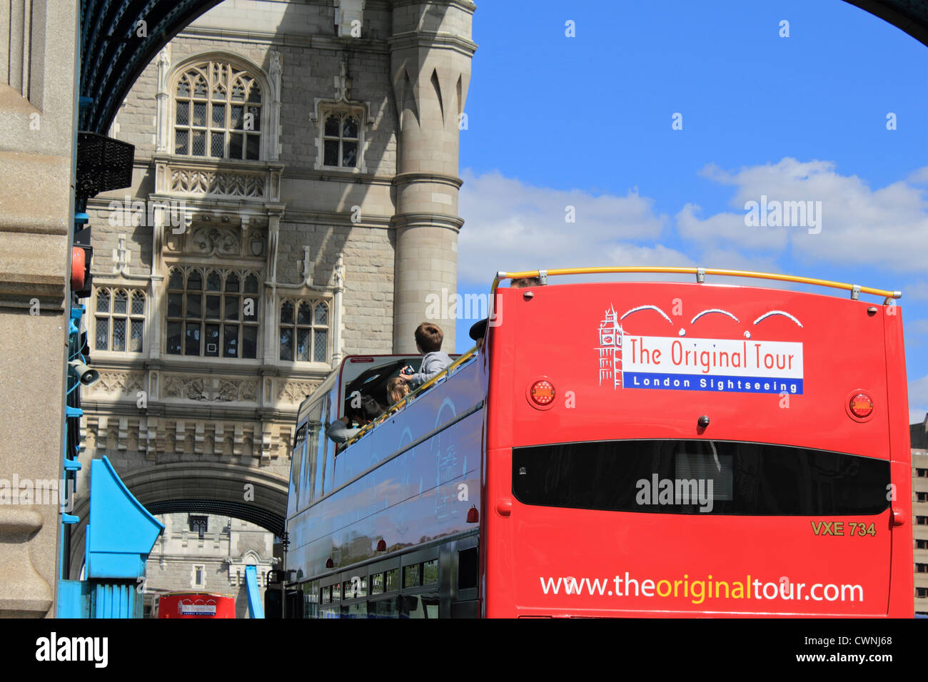 Red Tour Bus crossing Tower Bridge over the River Thames, London ...