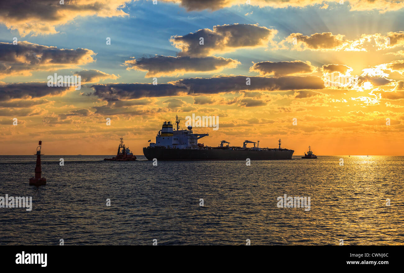 Solar Convoy - Tanker at sunset putting out to sea Stock Photo - Alamy