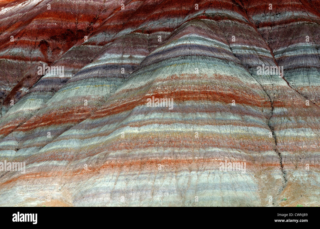 orange brown red colored coloured sandstone cliffs hills along highway ...