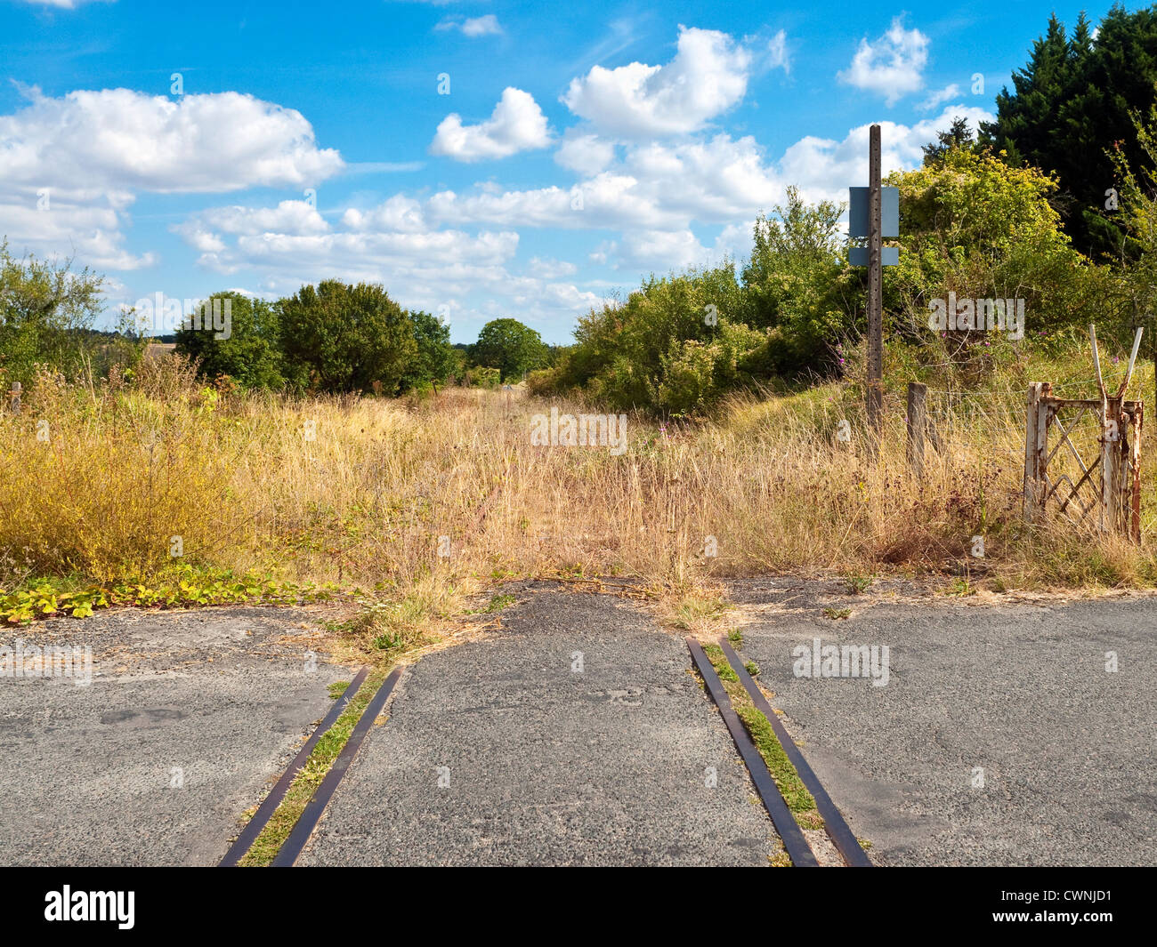 Disused railway track / resurfaced road crossing - France Stock Photo ...