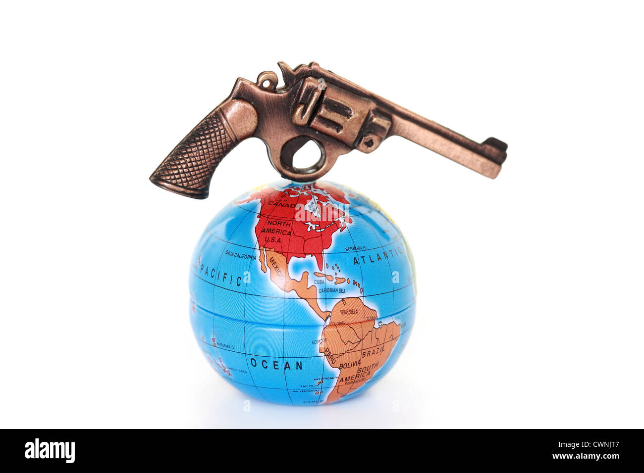 Toy gun on globe on white background Stock Photo - Alamy