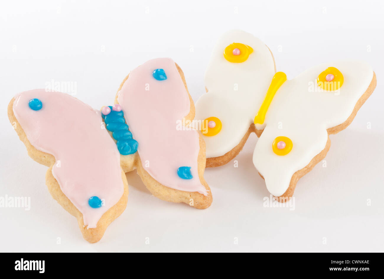 Two iced biscuits/cookies in the shape of a butterfly Stock Photo - Alamy