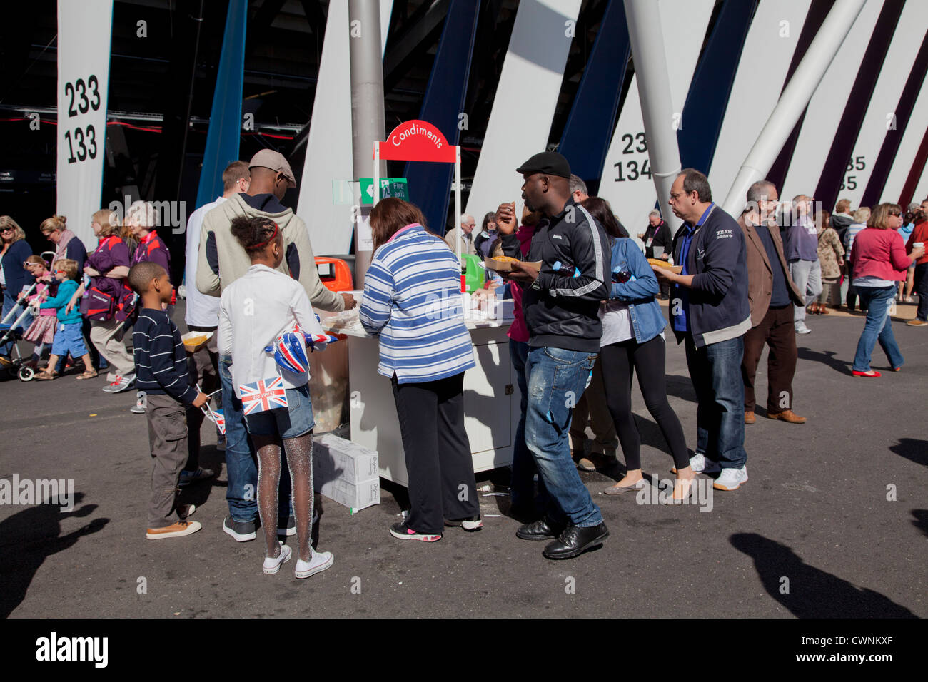 Spectators eating fast food outside London Olympic Stadium during the ...