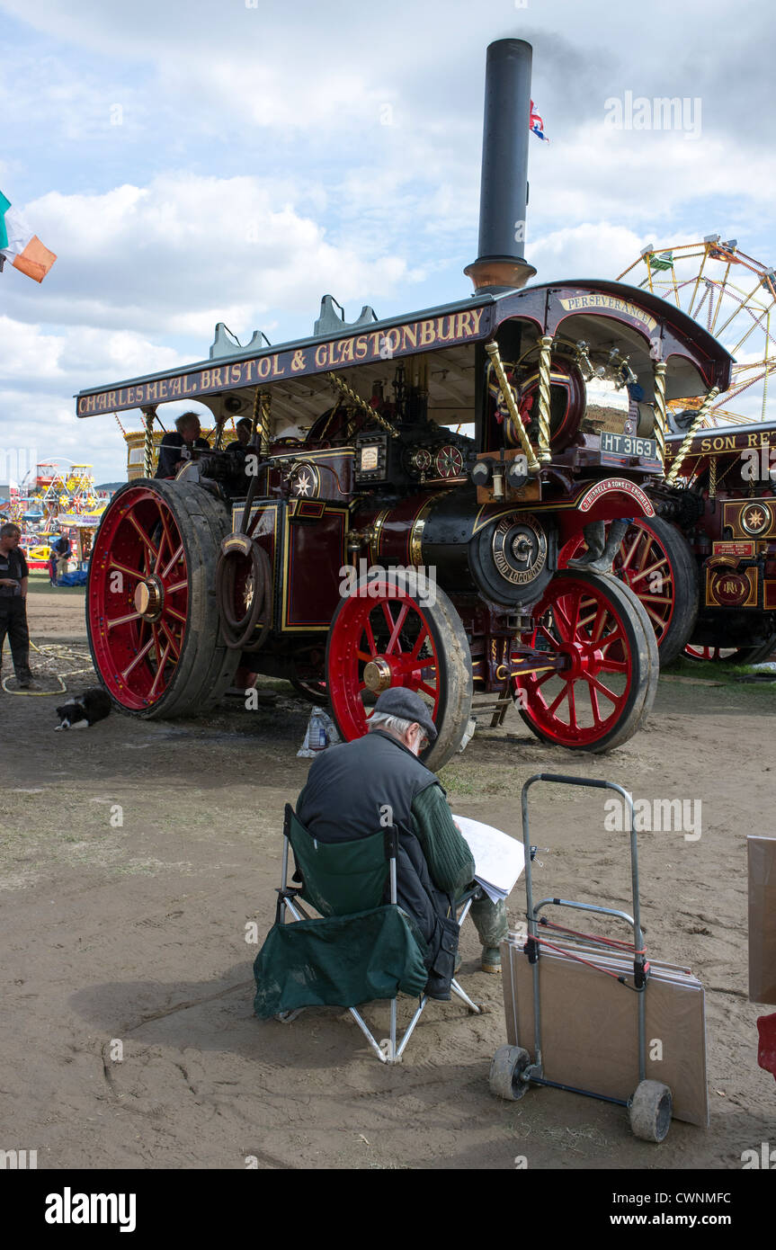 Man seated drawing a steam traction engine at the Great Dorset Steam ...