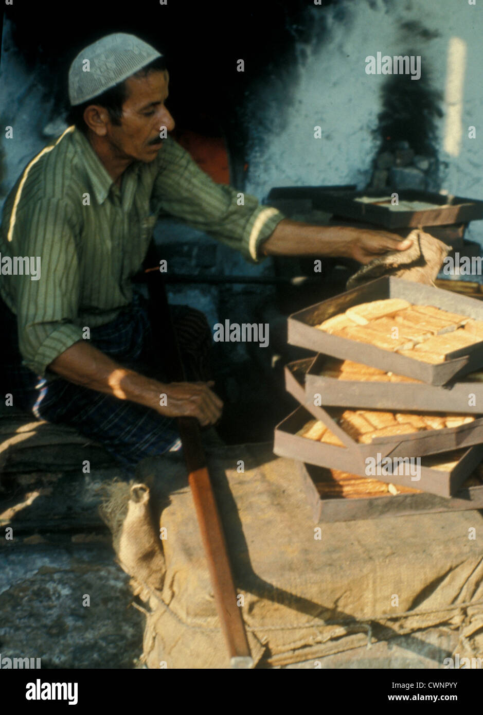 Man baking biscuits in Bahrain Stock Photo - Alamy