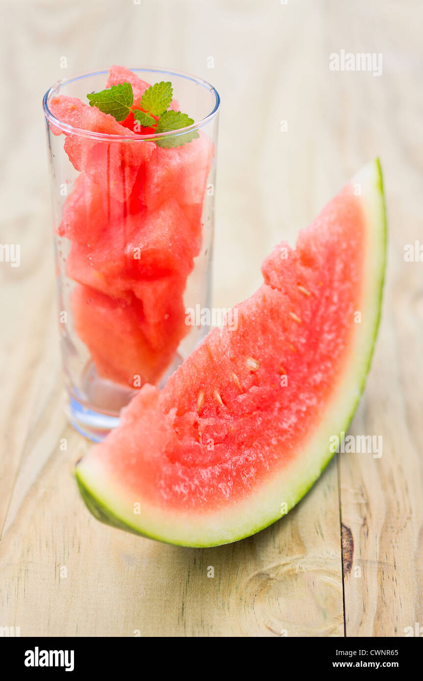 Glass with some pieces of watermelon and a piece of watermelon Stock ...