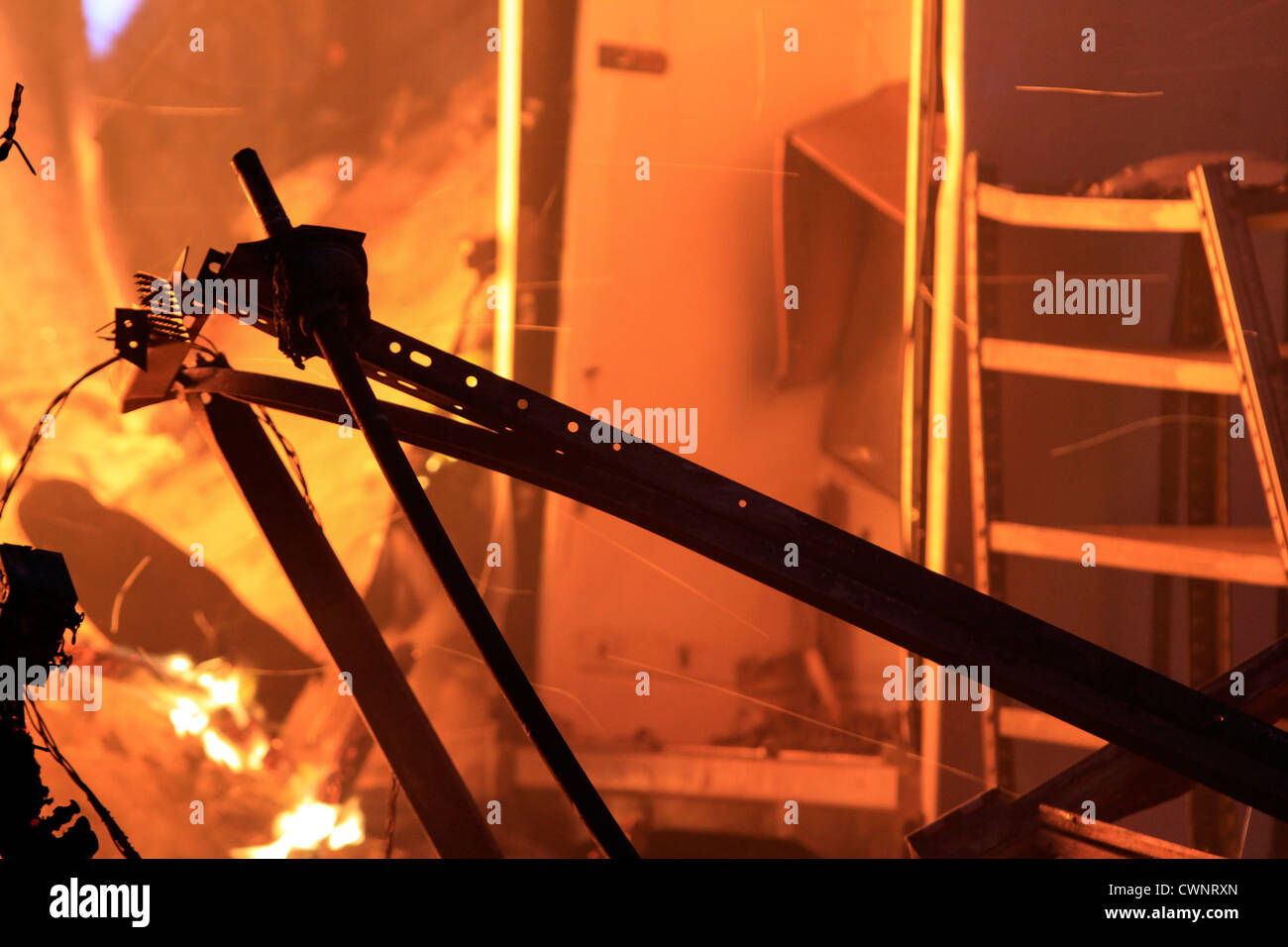 House interior destroyed by intense fire. Flames, smoke and sparks ...