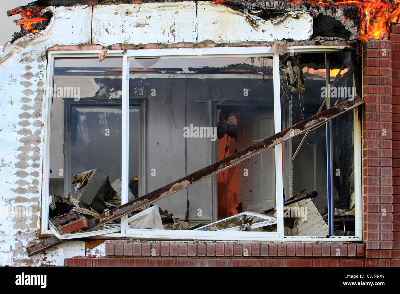 House interior destroyed by intense fire. Flames, smoke and sparks ...