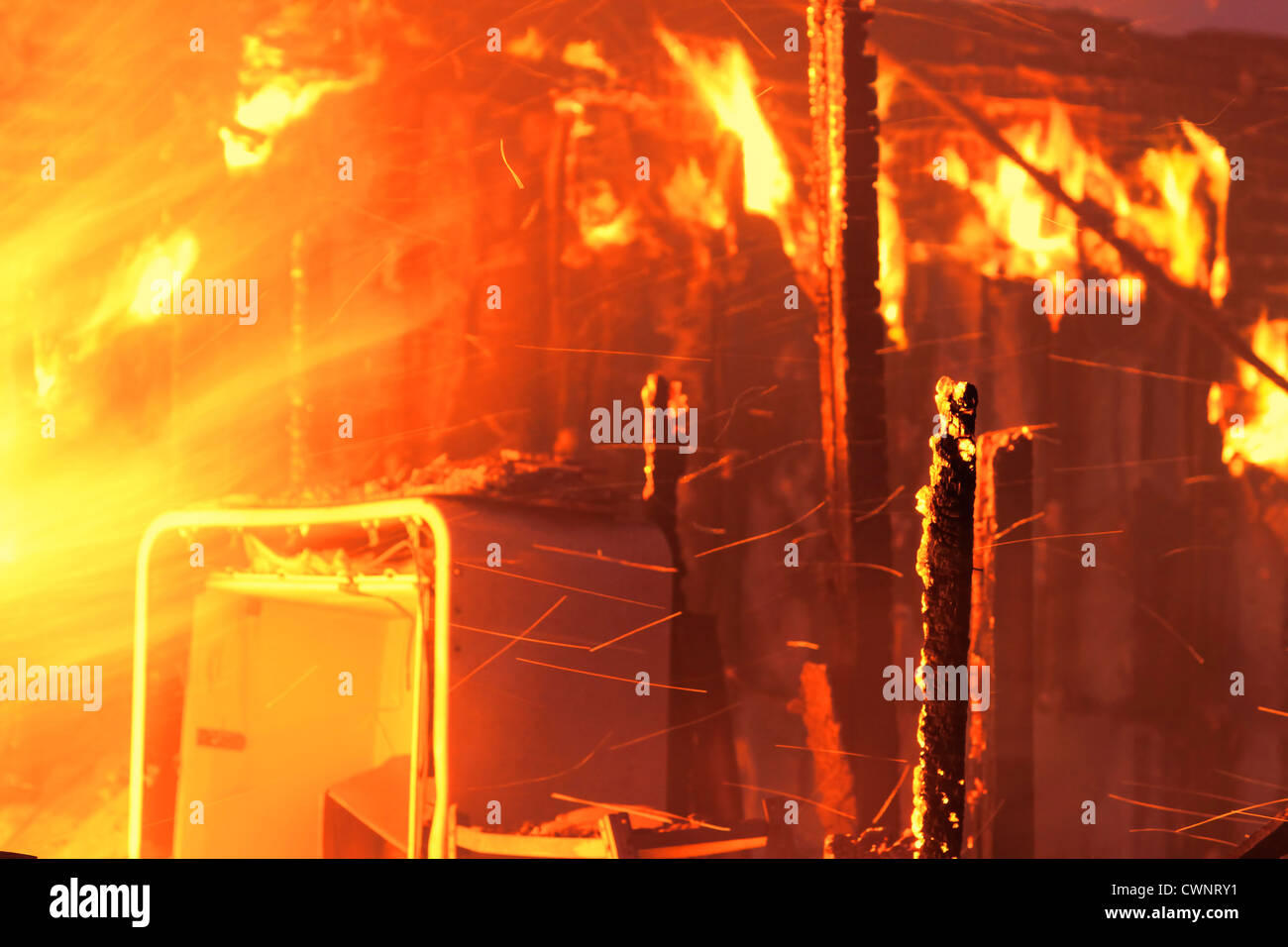 House interior destroyed by intense fire. Flames, smoke and sparks ...