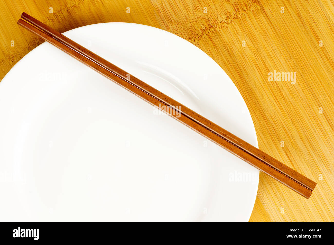 Chopsticks and plates isolated on the table Stock Photo - Alamy
