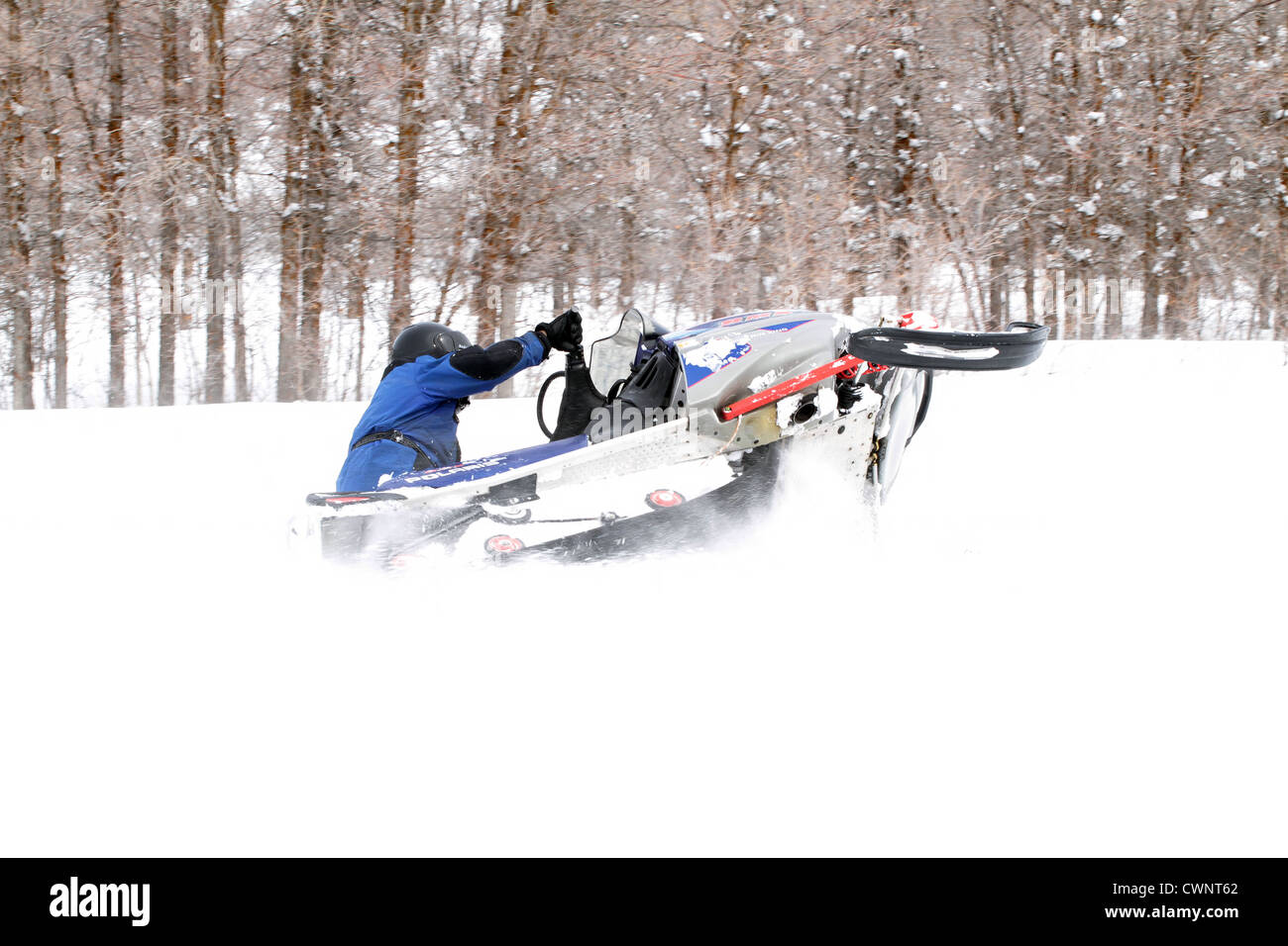 Snowmobile rider having fun and turning in fresh white snow. Sharp ...