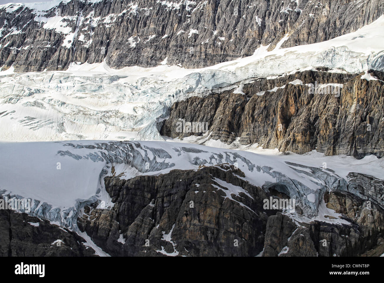 Glacial ice in Canada with tinges of turquoise blue on rocky ledges ...
