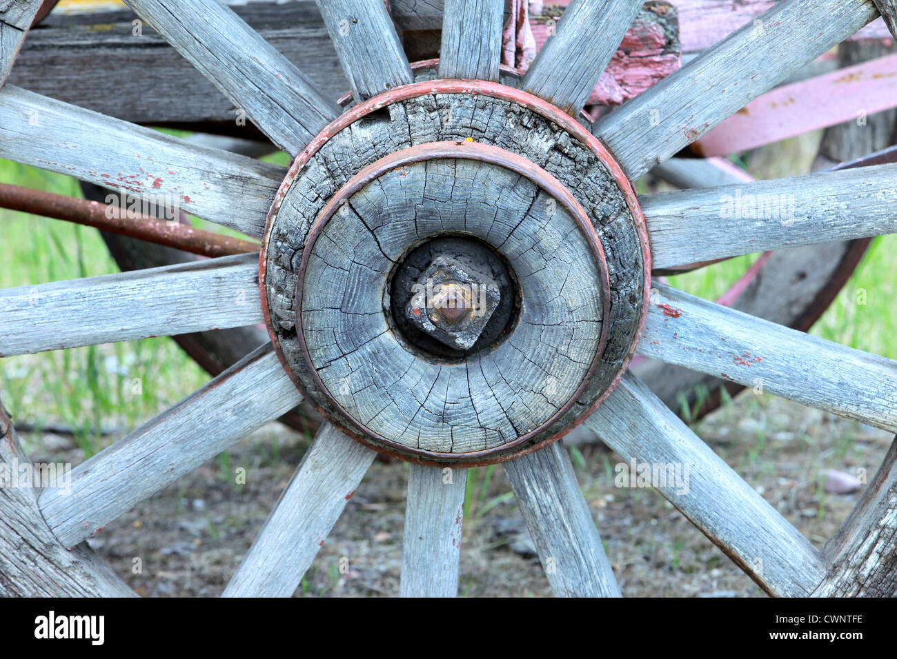 Old, antique wagon wheel with weathered wood and rusty metal parts in a ...