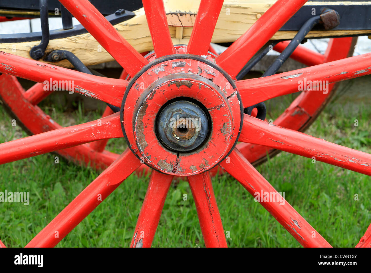 Old, antique wagon wheel with weathered wood and rusty metal parts in a ...