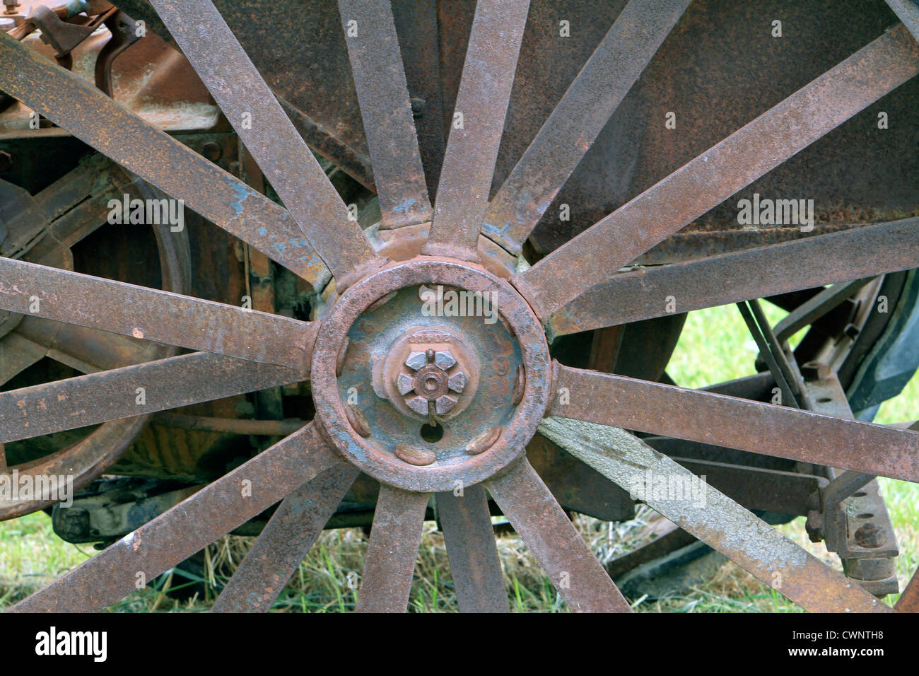 Old, antique wagon wheel with weathered wood and rusty metal parts in a ...