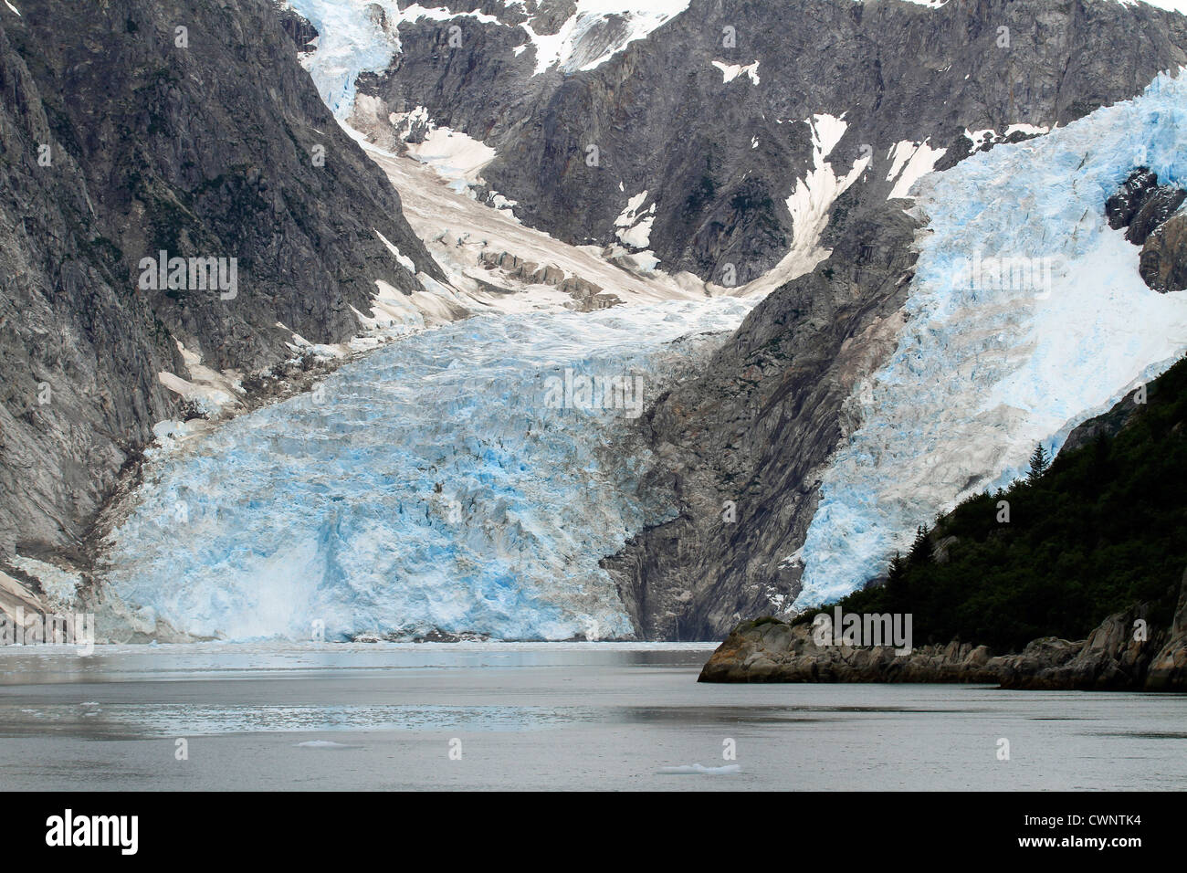 Glacial ice in Canada with tinges of turquoise blue on rocky ledges ...