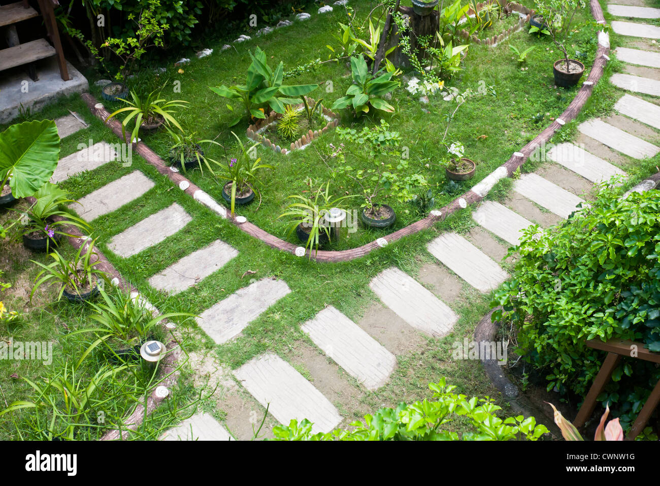 Stone paved footpath through garden Stock Photo - Alamy