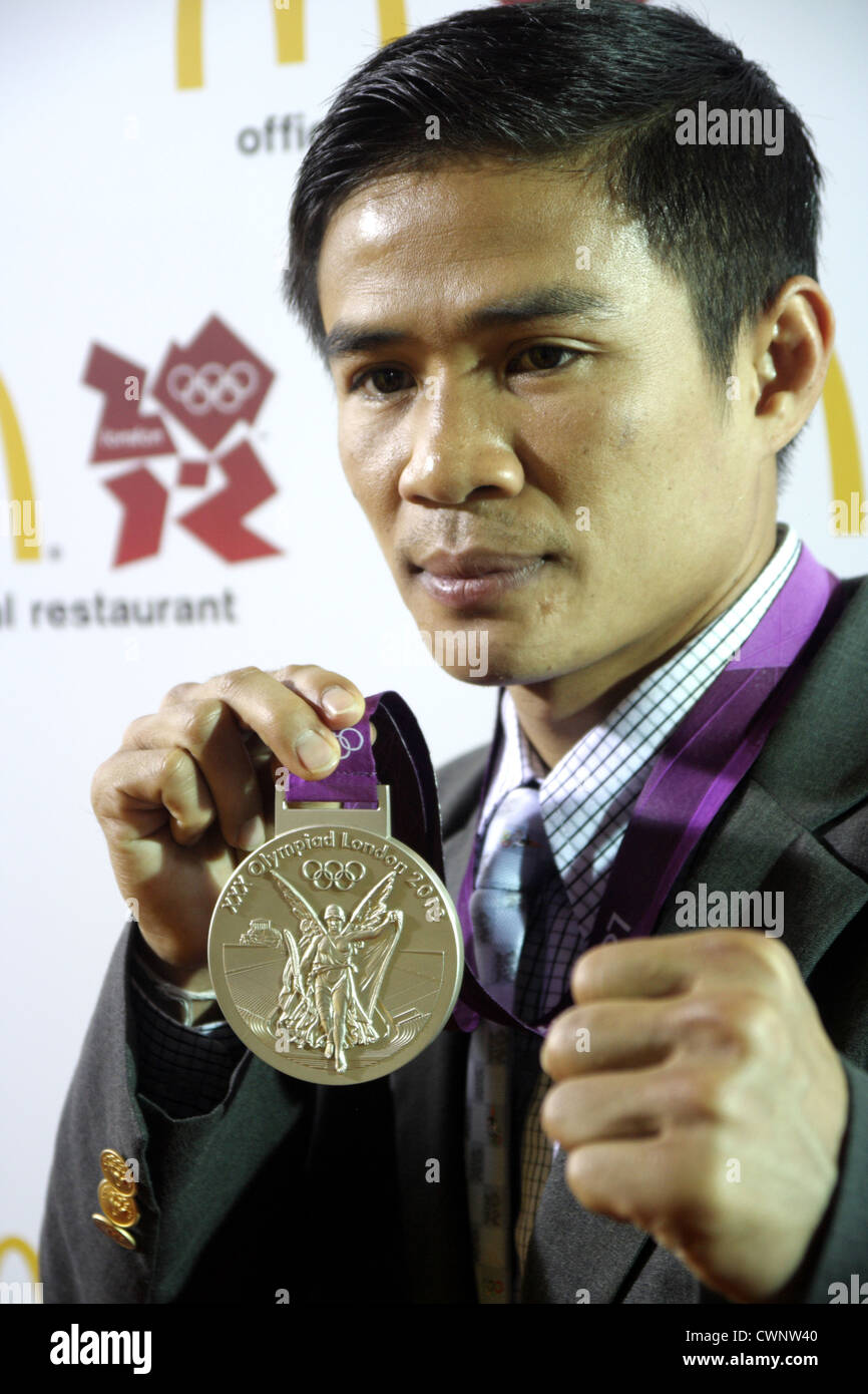 Thai light flyweight boxer, Kaeo Pongprayoon shows his silver medal ...