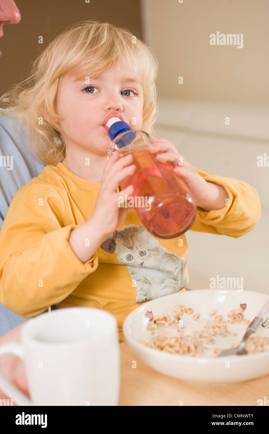 Girl drinking water in breakfast Stock Photo - Alamy