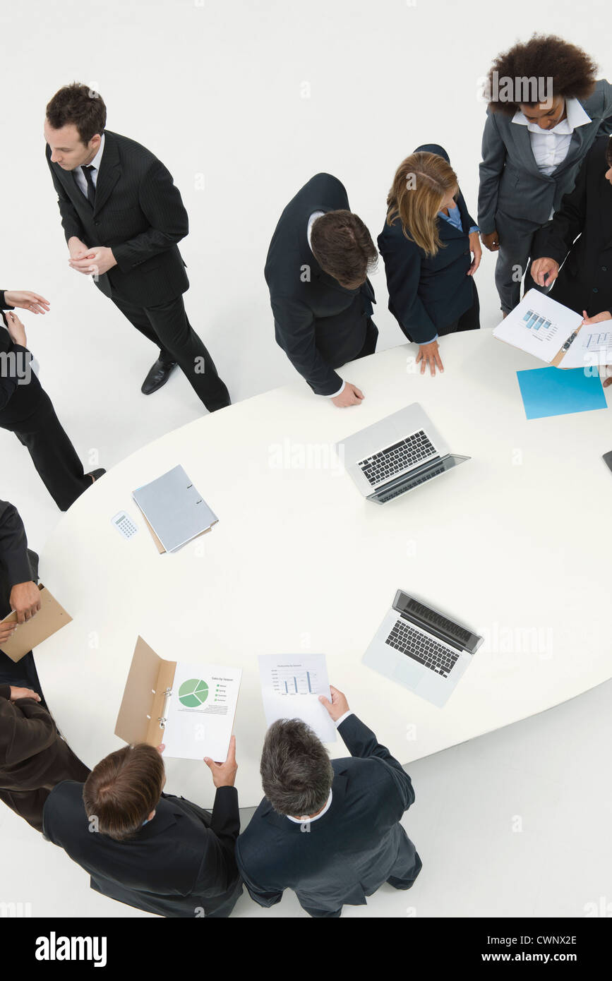 Business associates working together in small groups around table Stock ... Business associates working together in small groups around table Stock ...