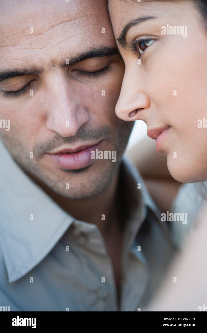 Couple embracing with cheeks touching, cropped Stock Photo - Alamy
