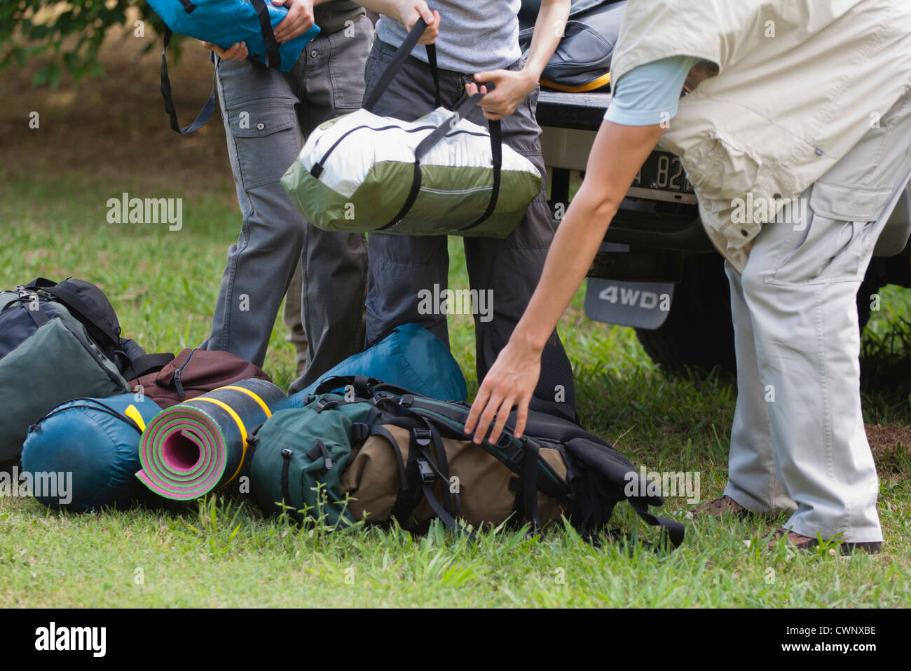Campers unloading camping gear, low section Stock Photo - Alamy
