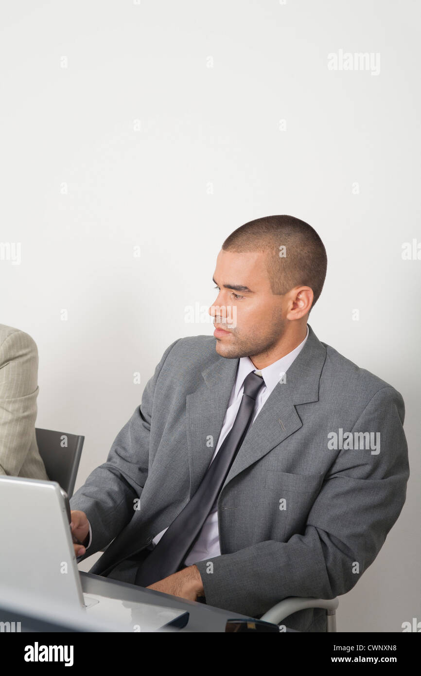 Young businessman using laptop computer Stock Photo - Alamy