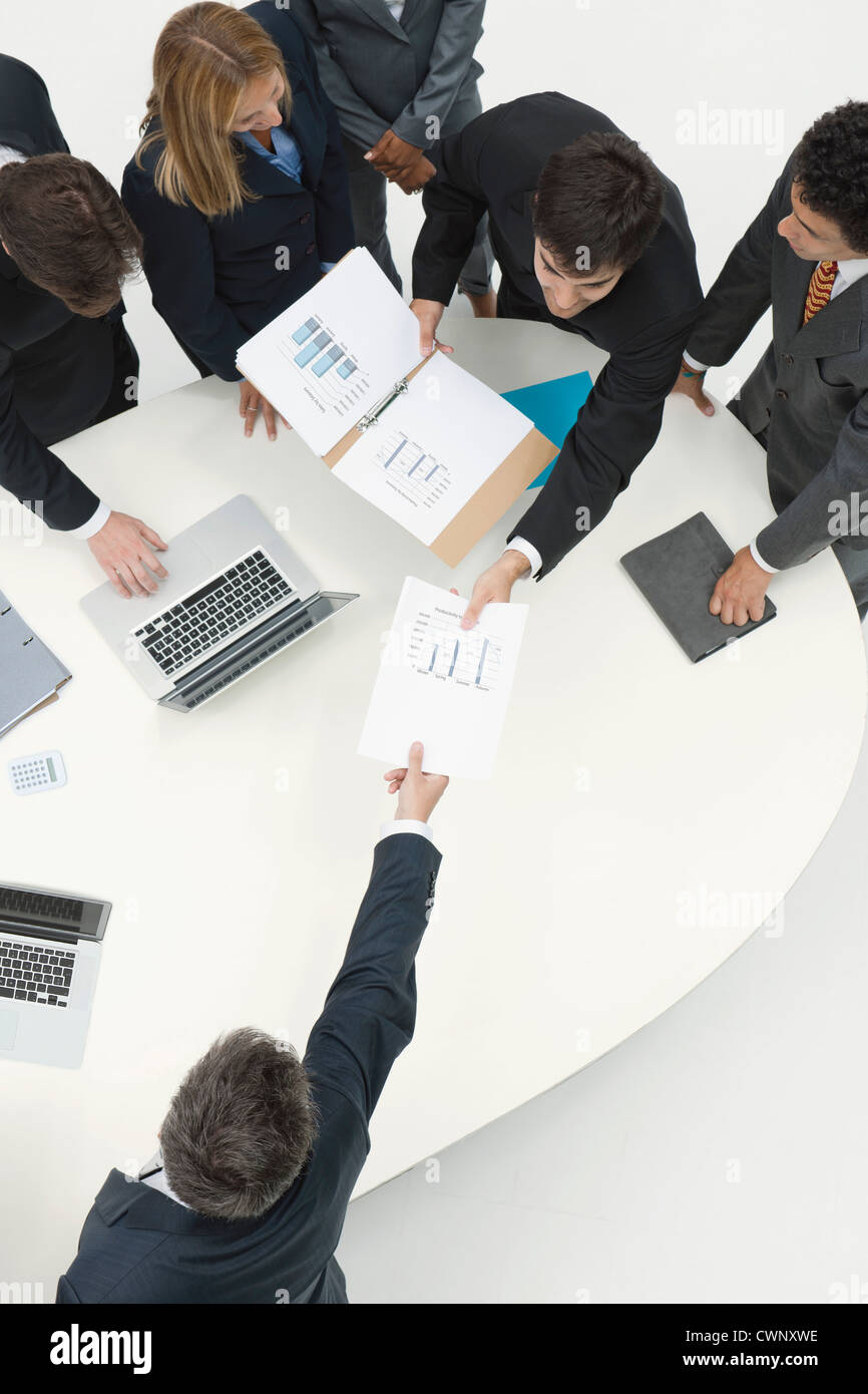 Business associates reviewing documents in meeting Stock Photo - Alamy