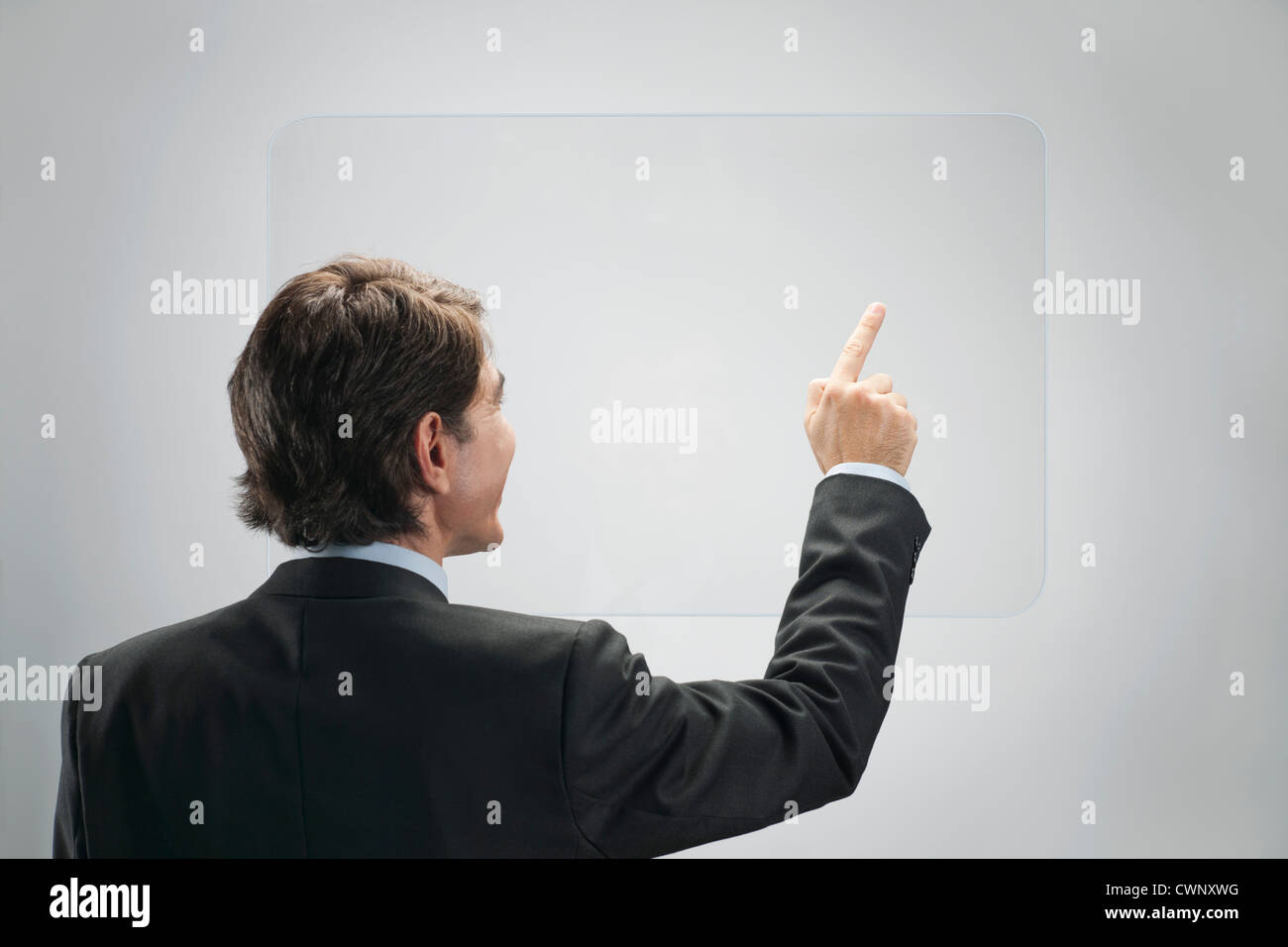 Businessman using large transparent touch screen Stock Photo - Alamy